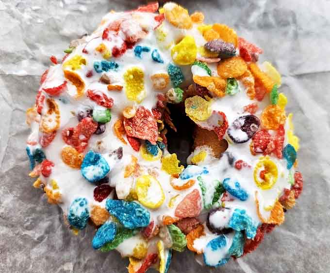 Mermaid Donut: A carnival of color and crunch that somehow works harmoniously. Fruity cereal has never found a more perfect home than atop this vanilla-glazed wonder.