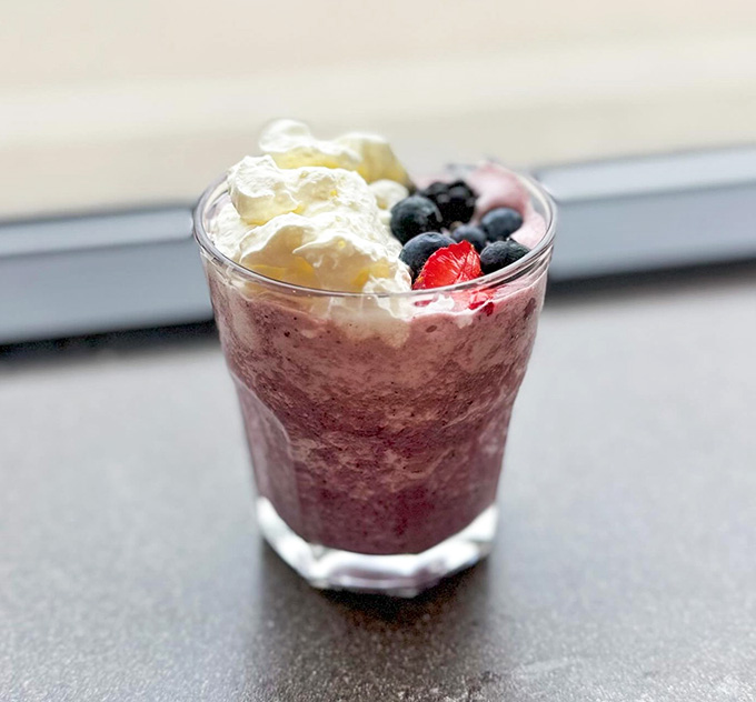 This berry smoothie topped with whipped cream and fresh fruit looks almost too pretty to drink, but you'll be glad you did anyway.