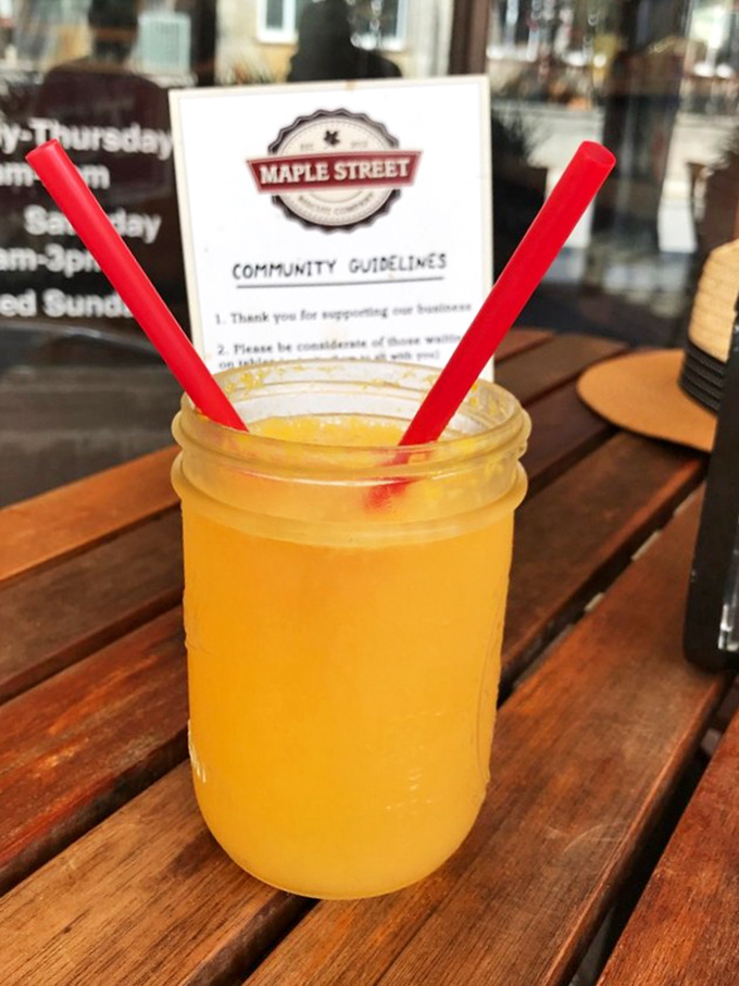 A mason jar of sunshine masquerading as a mimosa, the perfect companion for decisions like "Should I order a second biscuit?" (Spoiler: Yes)