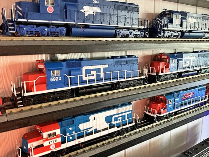 Railroad enthusiasts marvel at this impressive display of diesel locomotives, where American railroading history is preserved in miniature form.
