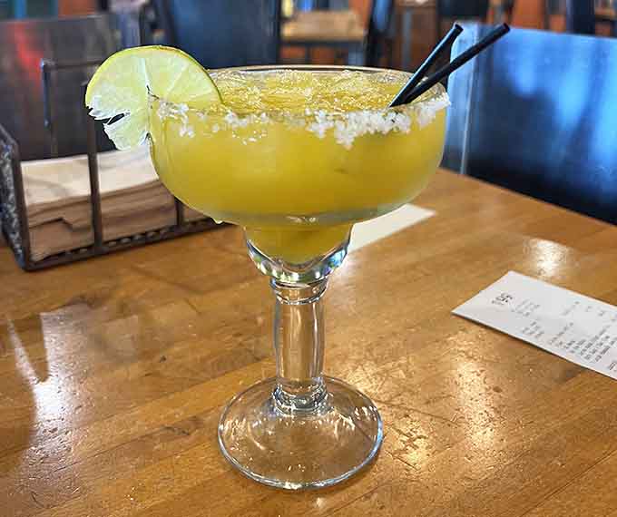 A margarita with a salt rim sits ready to complement your meal, because sometimes dinner needs a little liquid sunshine.