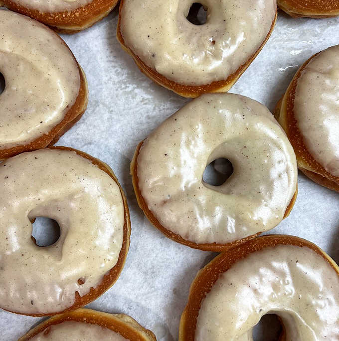 A tray of freshly glazed brown butter donuts cooling before their debut. The anticipation is almost as delicious as the donuts themselves.