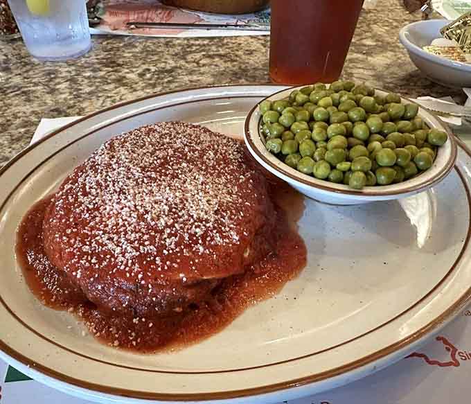Veal parmigiana with a side of peas proves this kitchen knows its way around more than just spaghetti magic.