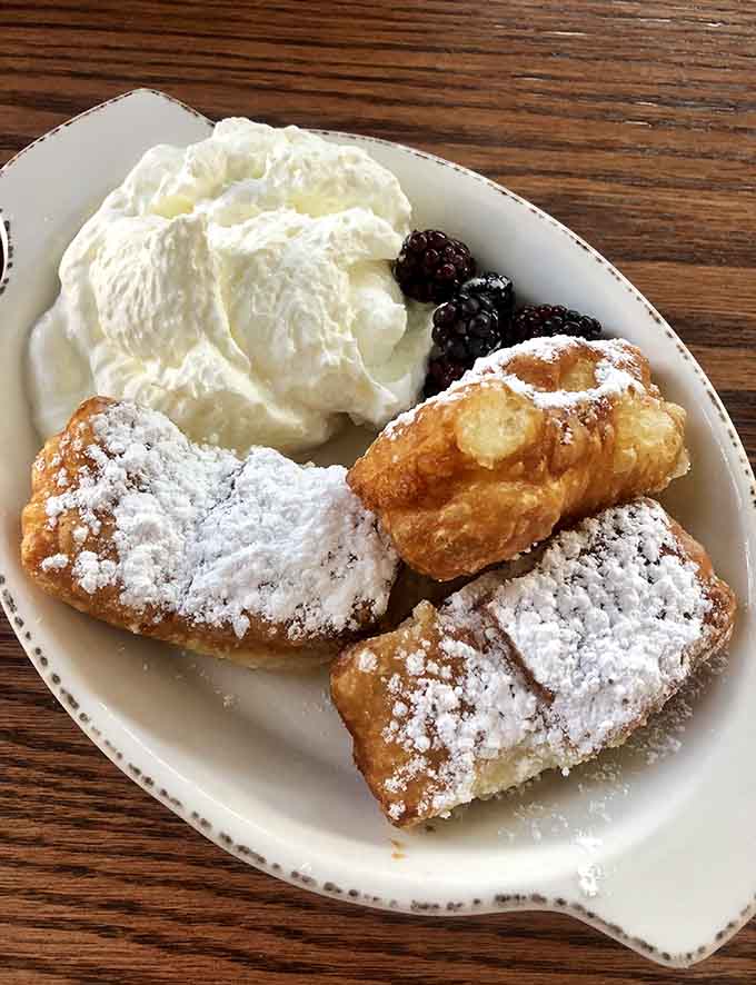 Beignets dusted with powdered sugar and crowned with fresh berries and whipped cream, because sometimes you need a little New Orleans in Minnesota.