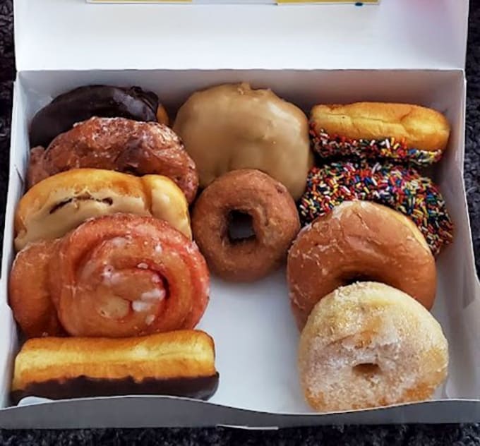 An assorted dozen that showcases the range and quality, from classic glazed to chocolate-covered to those magnificent fritters that steal the show.