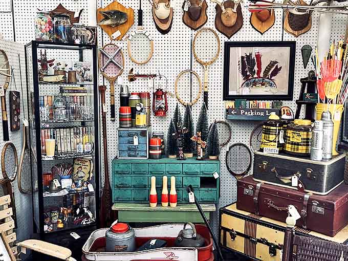 Vintage tennis rackets and sporting equipment hang like trophies of leisure time past&mdash;wooden craftsmanship that's survived decades of play.