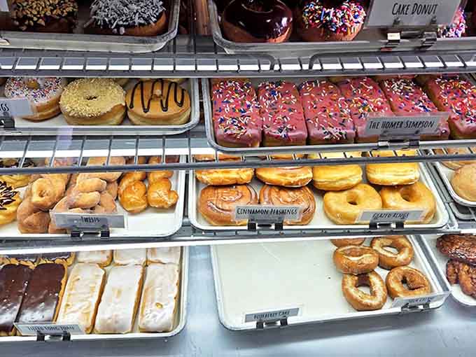 The display case &ndash; where diet plans go to die and breakfast dreams come true, one glazed masterpiece at a time.