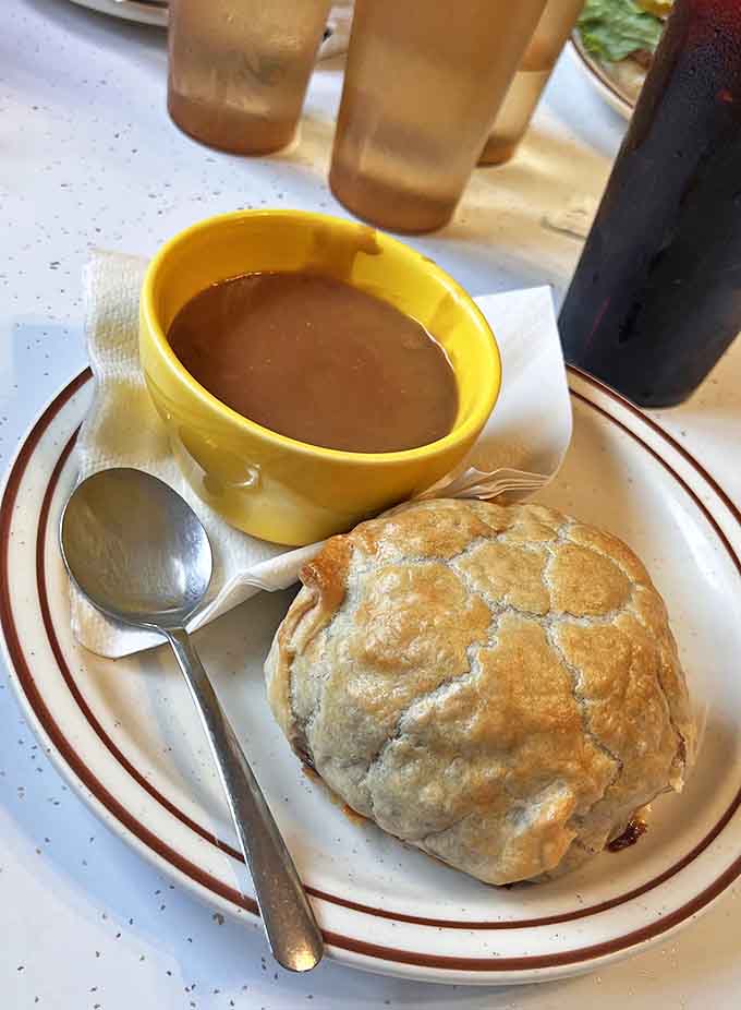 A proper Upper Peninsula pasty with gravy – miners' fuel transformed into comfort food perfection that sticks to your ribs.