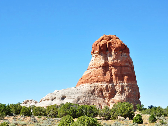 Layers of red, orange, and gold sediment tell Earth's autobiography in vivid color, each stratum a chapter millions of years in the making.