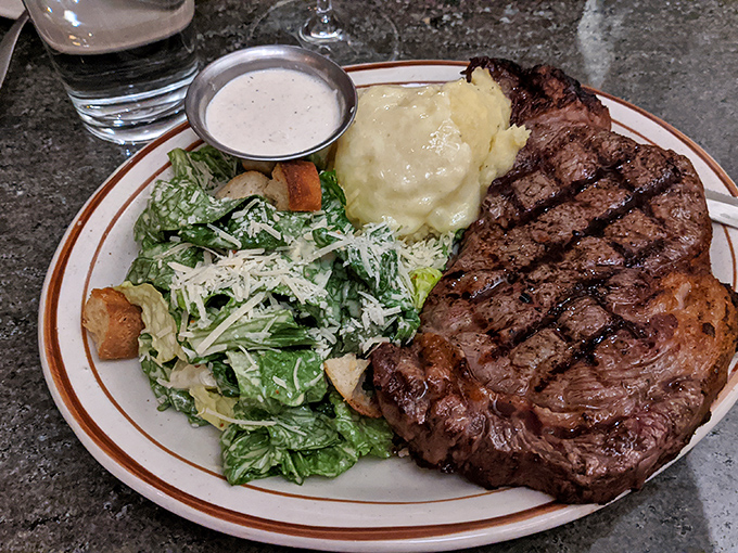 A carnivore's dream come true, perfectly grilled beef alongside creamy mashed potatoes and a Caesar salad that doesn't mess around.