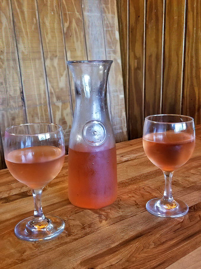 A carafe of rosé stands ready to complement your meal – because nothing says "I'm adulting properly" like pairing fine wine with world-class pizza.