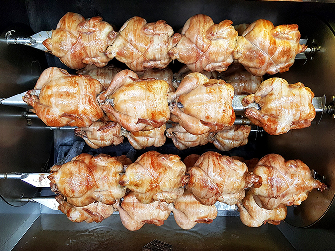 Rotisserie chickens spinning hypnotically as they transform into golden-brown masterpieces. The skin crispiness-to-meat juiciness ratio here is mathematical perfection.
