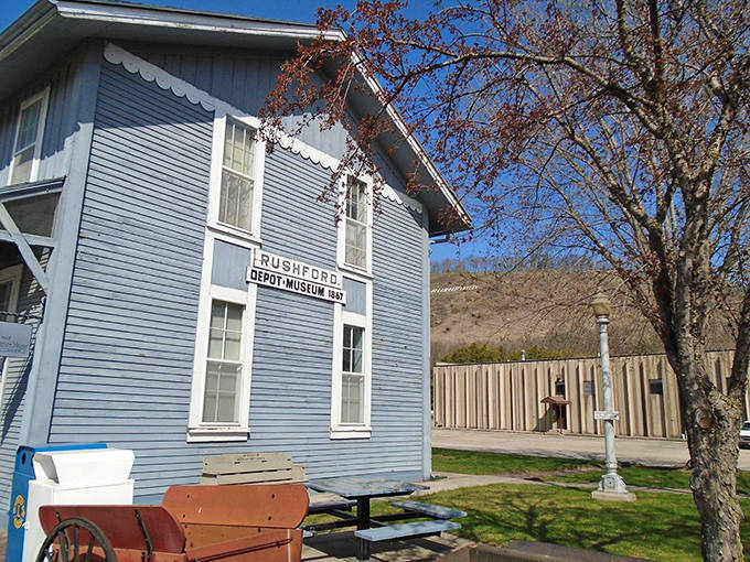 The blue Rushford Depot Museum stands as a cheerful guardian of local history, its color as bright as the stories inside.