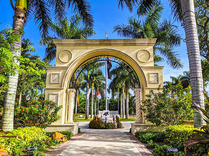 Memorial Park's elegant archway invites visitors into a tropical sanctuary where royal palms stand at attention like nature's honor guard.