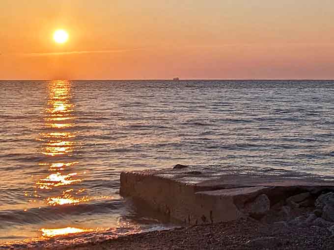 The sun makes its grand exit, painting a golden highway across Lake Huron's surface in a display that silences even the chattiest visitors.