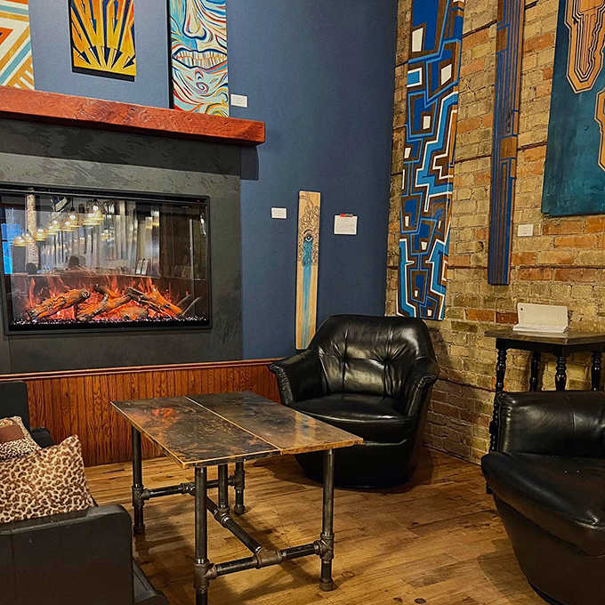 Pendant lights cast a golden glow over this corner sanctuary where brick walls and local art create the perfect backdrop for caffeine-fueled contemplation.