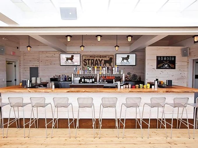 Michigan craft beers line up like liquid soldiers behind this sleek wooden bar, ready to quench thirsts and complement the kitchen's coastal creations.