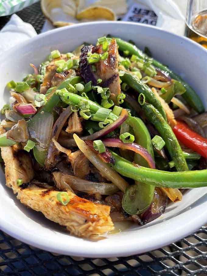 Teriyaki Chicken Bowl showcases fresh vegetables and tender meat, like a vacation to the Pacific Rim without leaving your comfortable booth.c