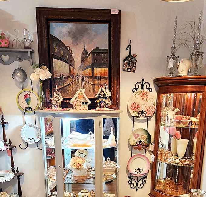 A Paris street scene watches over a collection of decorative plates and crystal &ndash; the perfect backdrop for imagining elegant dinner parties past.