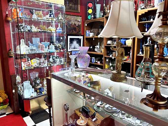 Vintage lampshades and glassware creating a display prettier than most people's actual living rooms, proving old doesn't mean outdated.