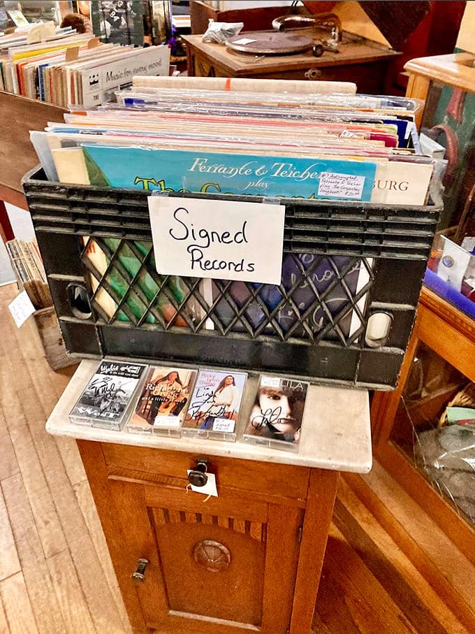 Signed vinyl records proving that autographs used to mean something before everyone became Instagram famous for fifteen minutes.