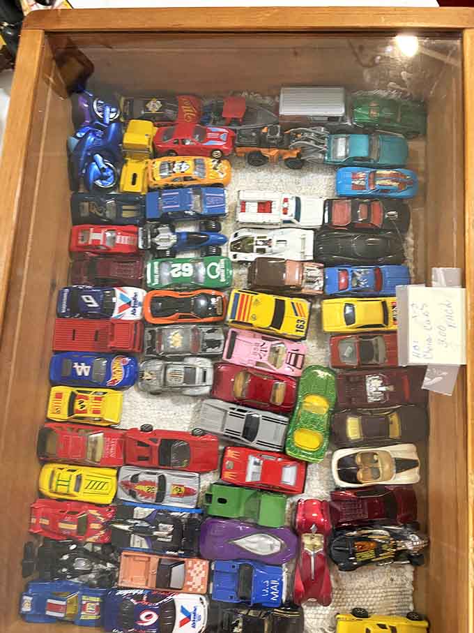 A toy car collection that would make any kid from the 1960s weep with joy, carefully preserved behind glass.