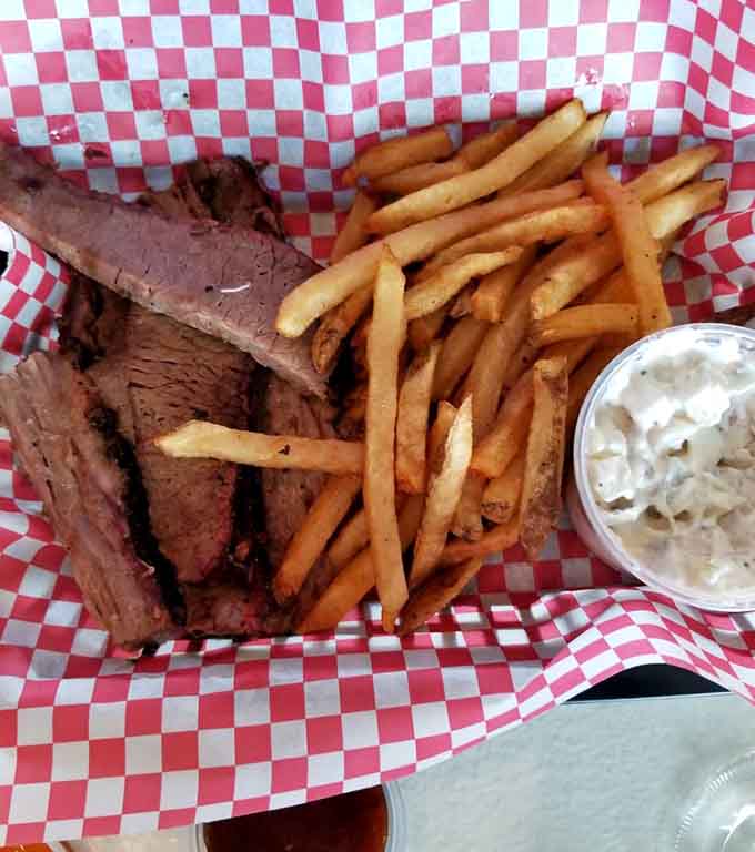 Sliced brisket with a smoke ring that would make any pitmaster proud, tender enough to cut with a plastic fork but flavorful enough to remember.