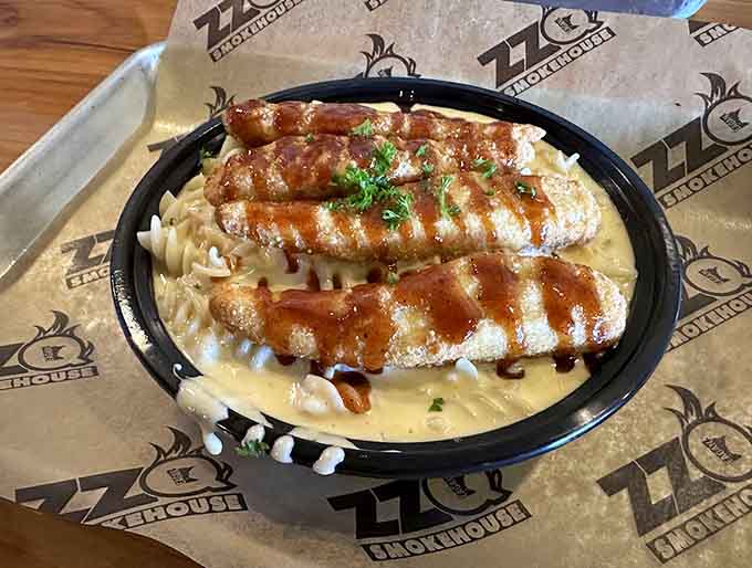 Mac and cheese with what appears to be smoked meat on top, turning comfort food into something that requires a nap afterward.