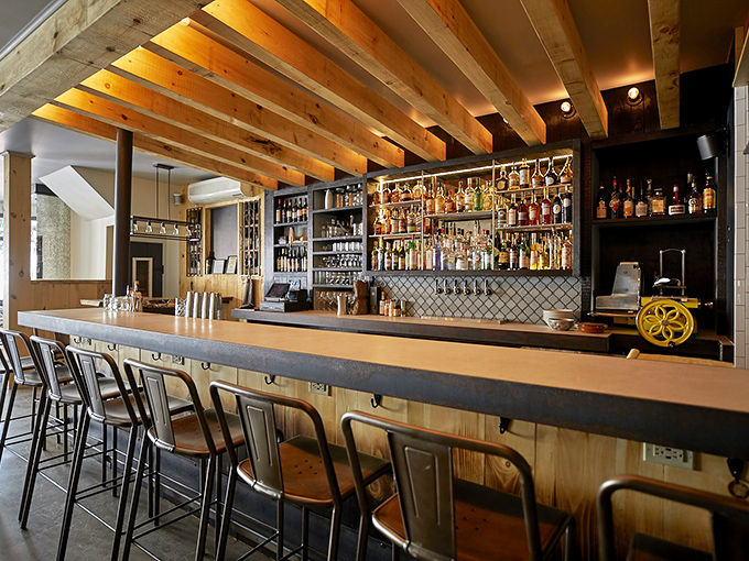 The bar at Chaval invites lingering, with warm wood tones and an impressive array of spirits promising libations crafted with care and creativity.