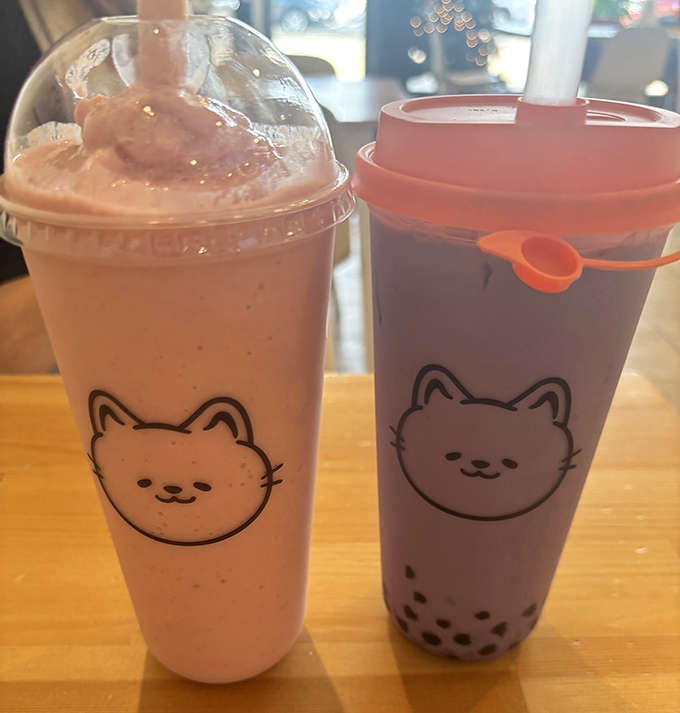 Bubble tea and milkshakes sitting pretty with that adorable cat logo, ready to wash down whatever sweet treats you've chosen.