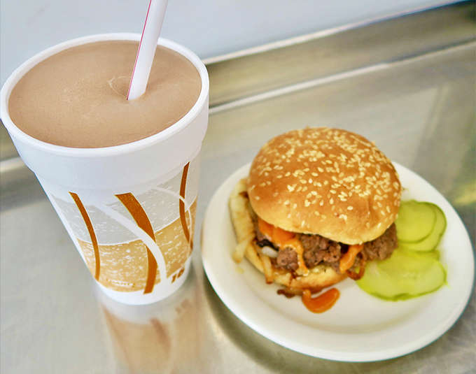 The chocolate shake stands at attention next to its burger companion &ndash; thick enough to require serious straw strength.