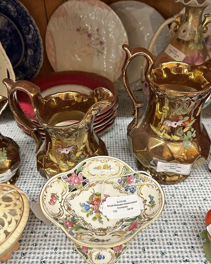 Delicate vintage pitchers and floral china glow together, showing the Vermont Antique Mall&rsquo;s charm and the quiet joy of finding beautifully preserved pieces.