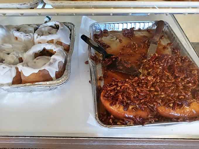 Cinnamon rolls and sticky buns waiting patiently in their pans, filling the air with an aroma that makes willpower completely irrelevant.