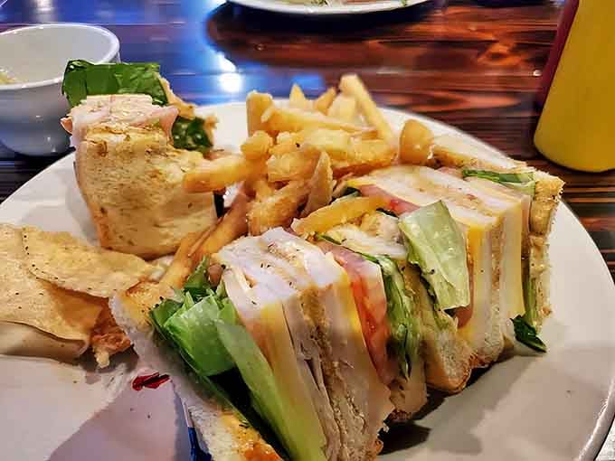 Their club sandwich requires a serious jaw stretch – layers of fresh ingredients stacked between perfectly toasted bread with crispy fries on the side.