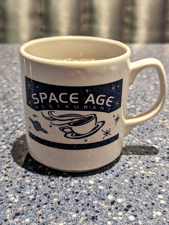 The Space Age Restaurant coffee mug – a coveted souvenir filled with robust brew that keeps desert explorers and UFO spotters properly caffeinated.