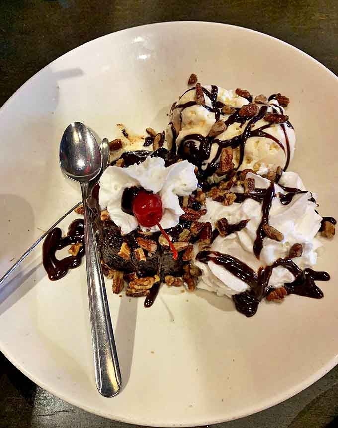 A mountain of ice cream, chocolate, and pecans creates the perfect sweet finale to a memorable meal.