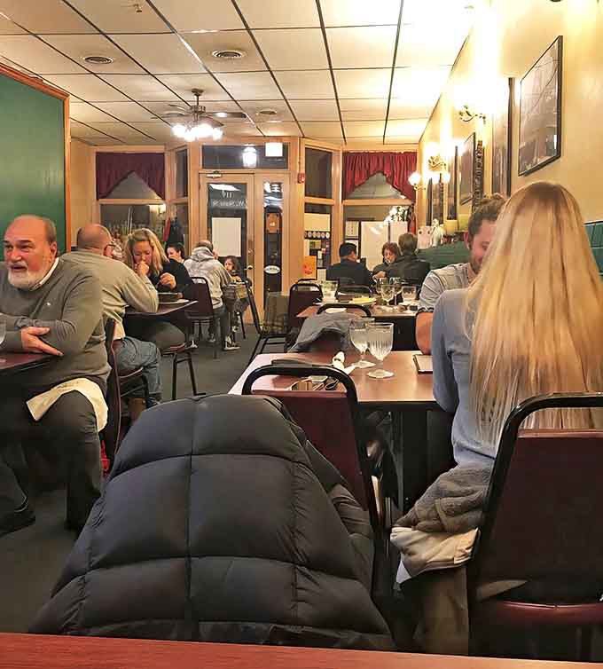 Happy diners fill the cozy space, creating that magical restaurant buzz that's as essential to a great meal as the food itself.