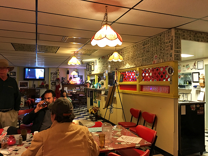 Where strangers become friends over shared pizza experiences, trading road trip stories beneath the glow of vintage lighting.