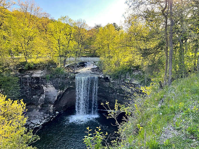 The waterfall's elegant plunge creates a perfect centerpiece, framed by nature's most vibrant seasonal palette.