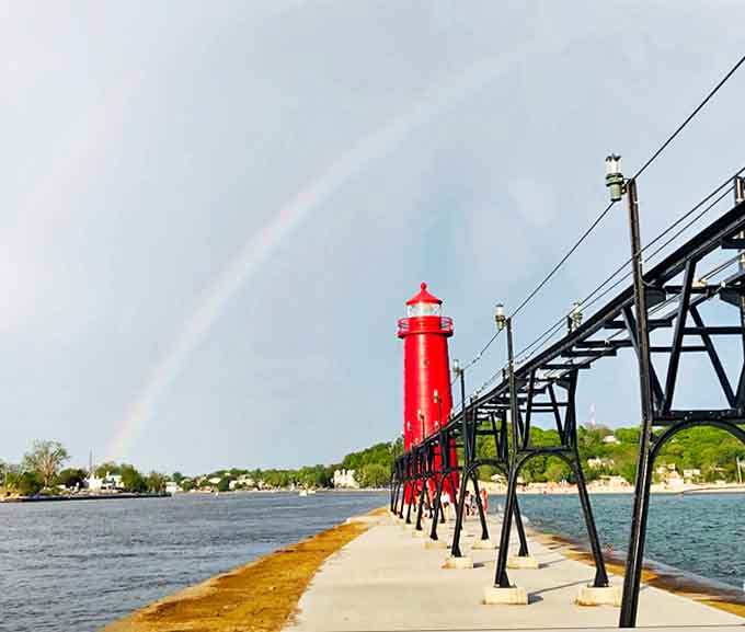 The lighthouse stands sentinel at the horizon where sky meets water, a timeless guardian of Lake Michigan's vast expanse.