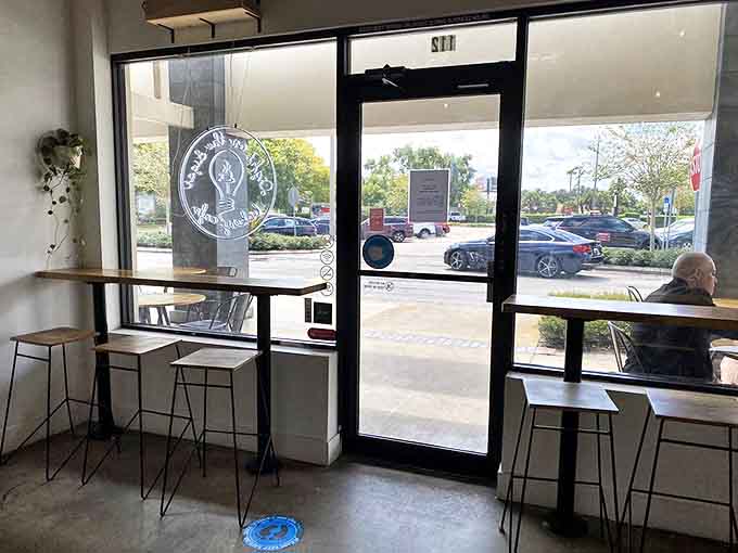 Window-side high-top seating offers prime people-watching opportunities while you debate ordering "just one more" cream puff.