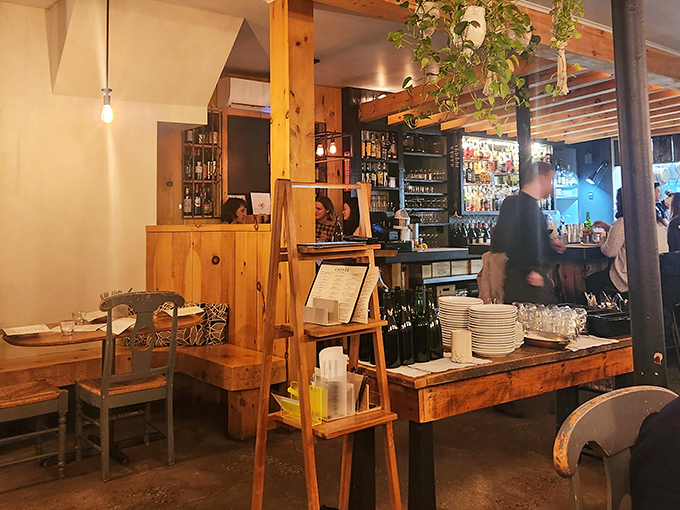 The bar area invites solo diners and couples alike, offering front-row seats to the culinary magic happening just beyond. Perfect for those who eat first with their eyes.