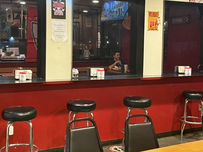A classic counter setup with red accents and stools creates a casual, no-frills spot for enjoying barbecue favorites.