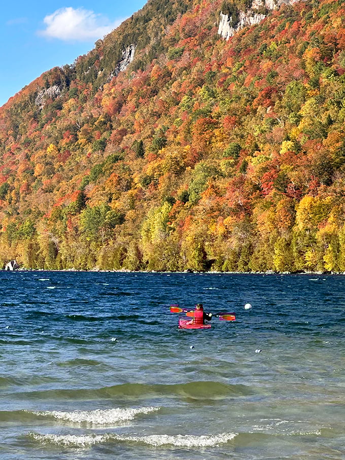 Autumn transforms the mountainside into a patchwork quilt of crimson, gold and orange, reflected perfectly in nature's mirror below.