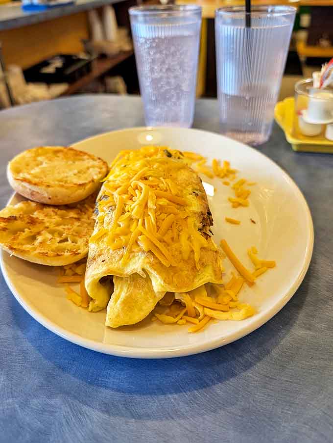 This cheese-crowned omelet doesn't just sit on the plate &ndash; it lounges regally, draped in melted cheddar like breakfast royalty.