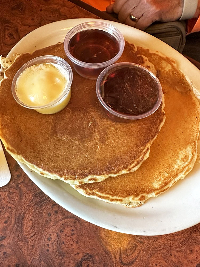 Pancakes so perfect they make you question why breakfast isn't served all day. Three sauces because life's too short for monogamous condiment relationships.