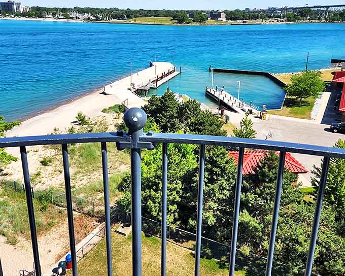The view from the lighthouse tower rewards climbers with a panoramic vista of Lake Huron's sparkling waters and the busy shipping channel below.