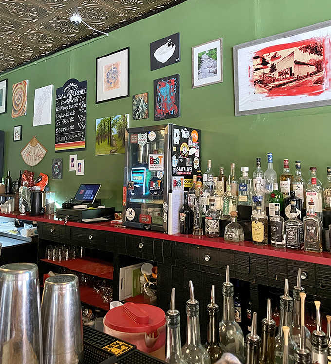 The bar area invites lingering conversations over craft cocktails, with bottles arranged like soldiers ready for delicious duty.