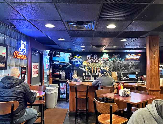 The bar area glows with neon signs and decades of history, where regulars gather to watch games and debate the best Juicy Lucy variations.