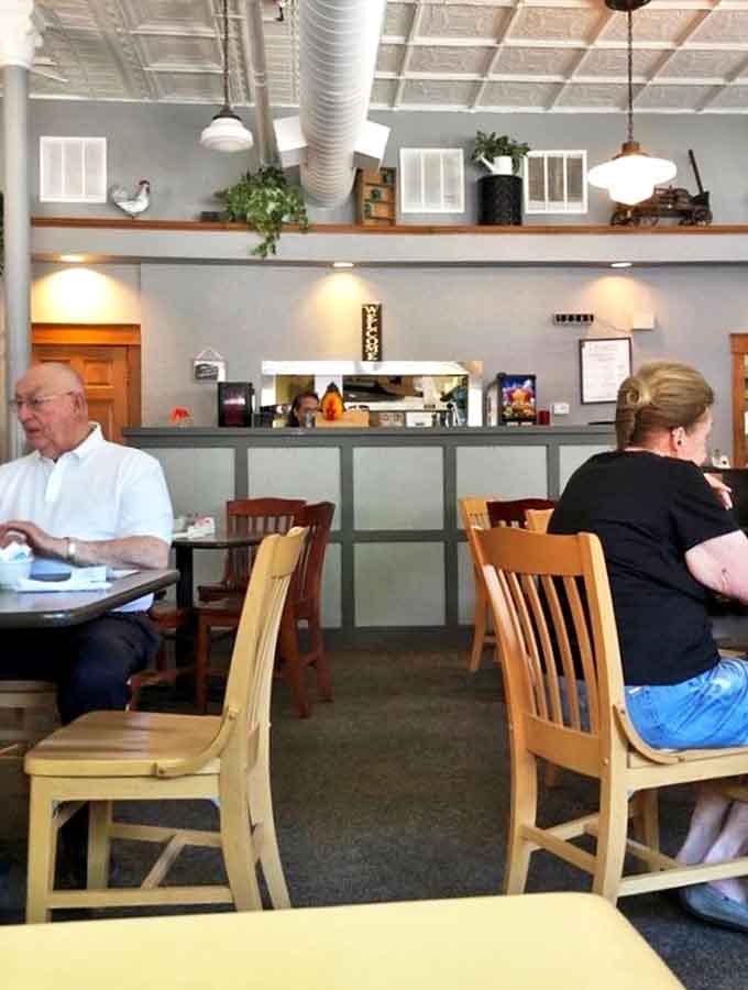 Simple tables invite lingering conversations over coffee and donuts &ndash; the kind of place where strangers become friends over shared sugar rushes.